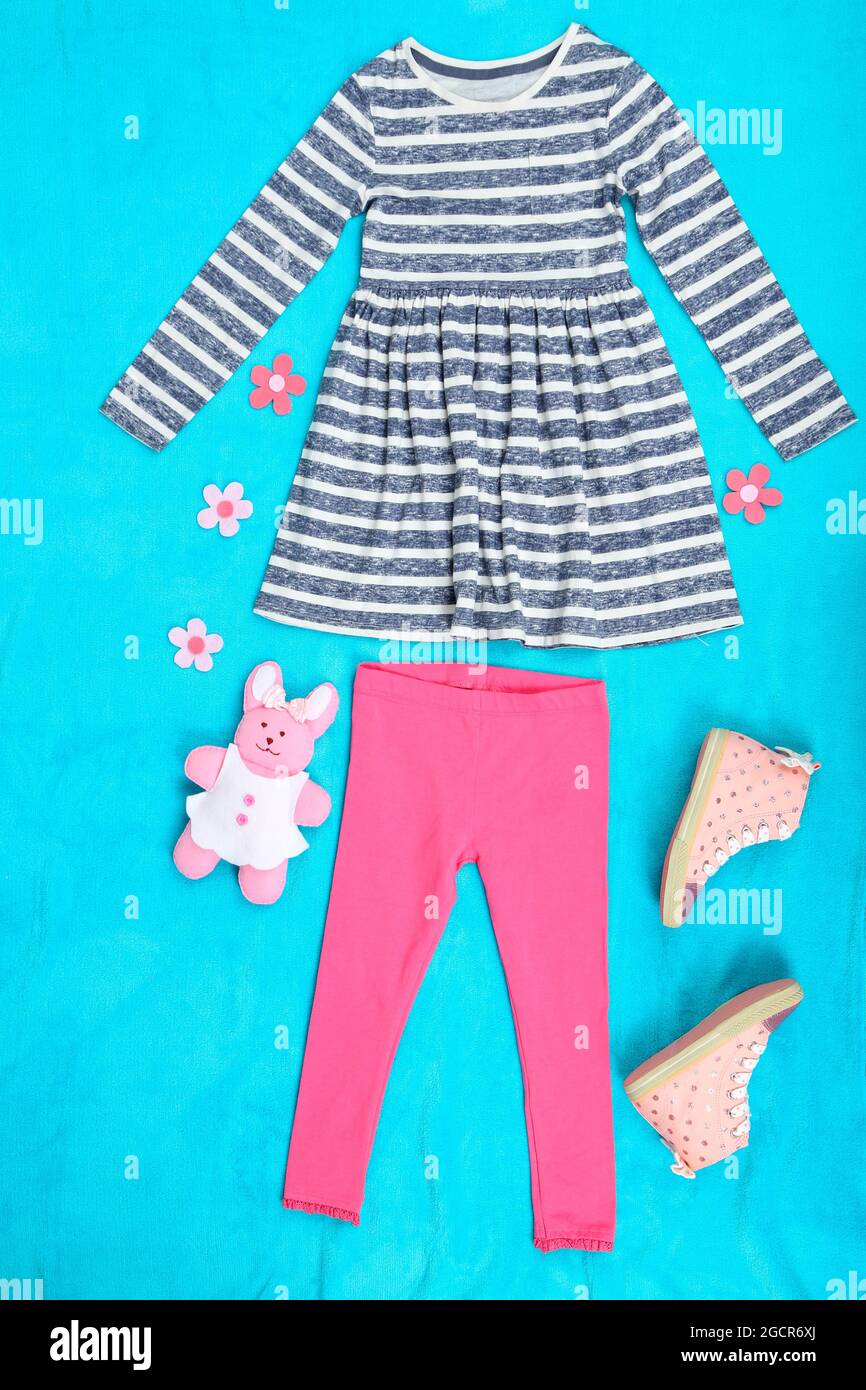 Beautiful clothes for little girl on blue background Stock Photo - Alamy