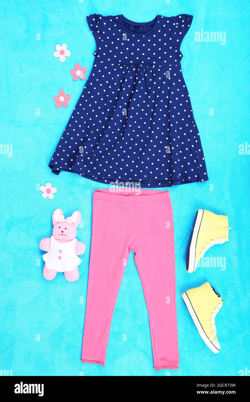 Beautiful clothes for little girl on blue background Stock Photo - Alamy
