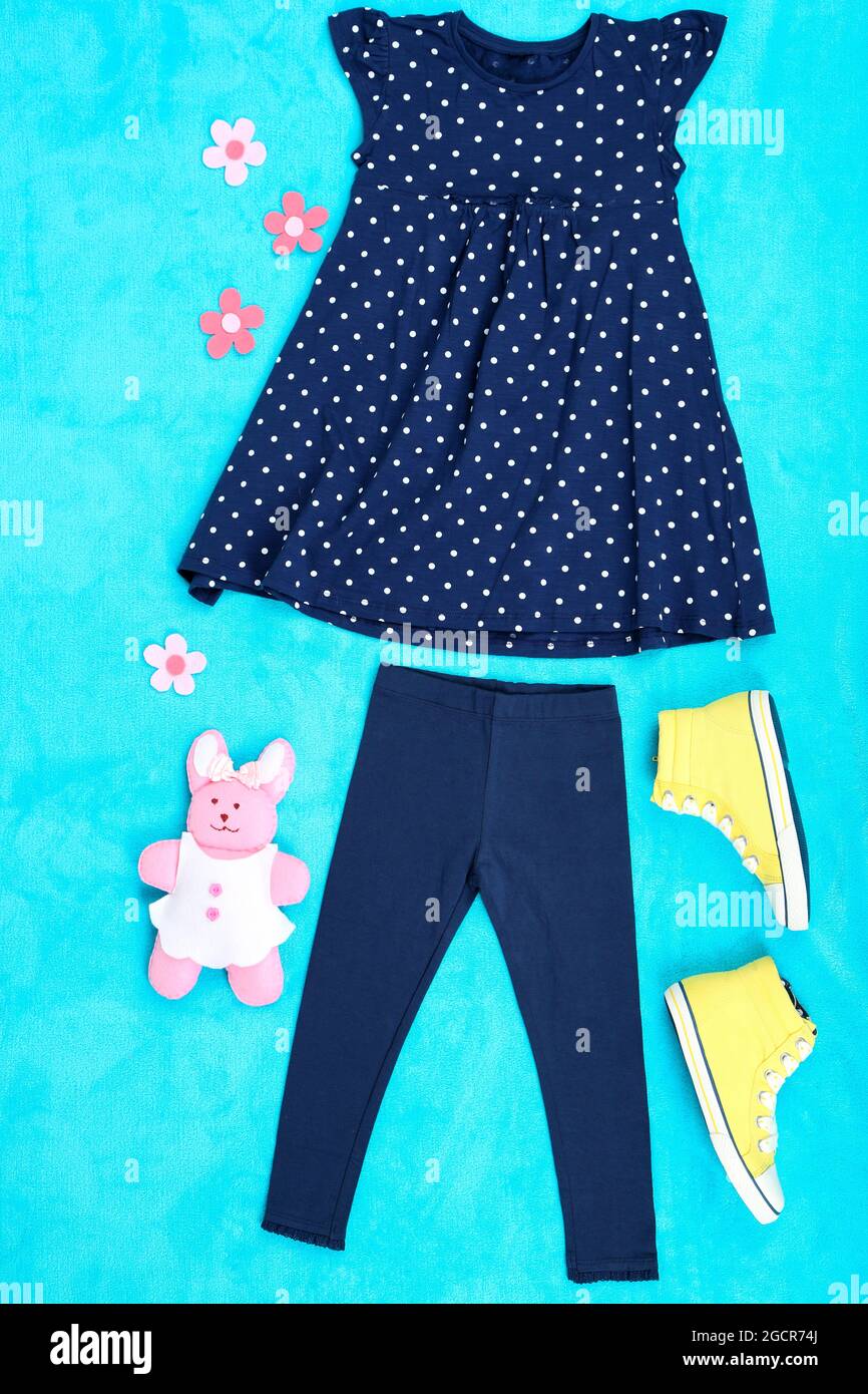 Beautiful clothes for little girl on blue background Stock Photo - Alamy