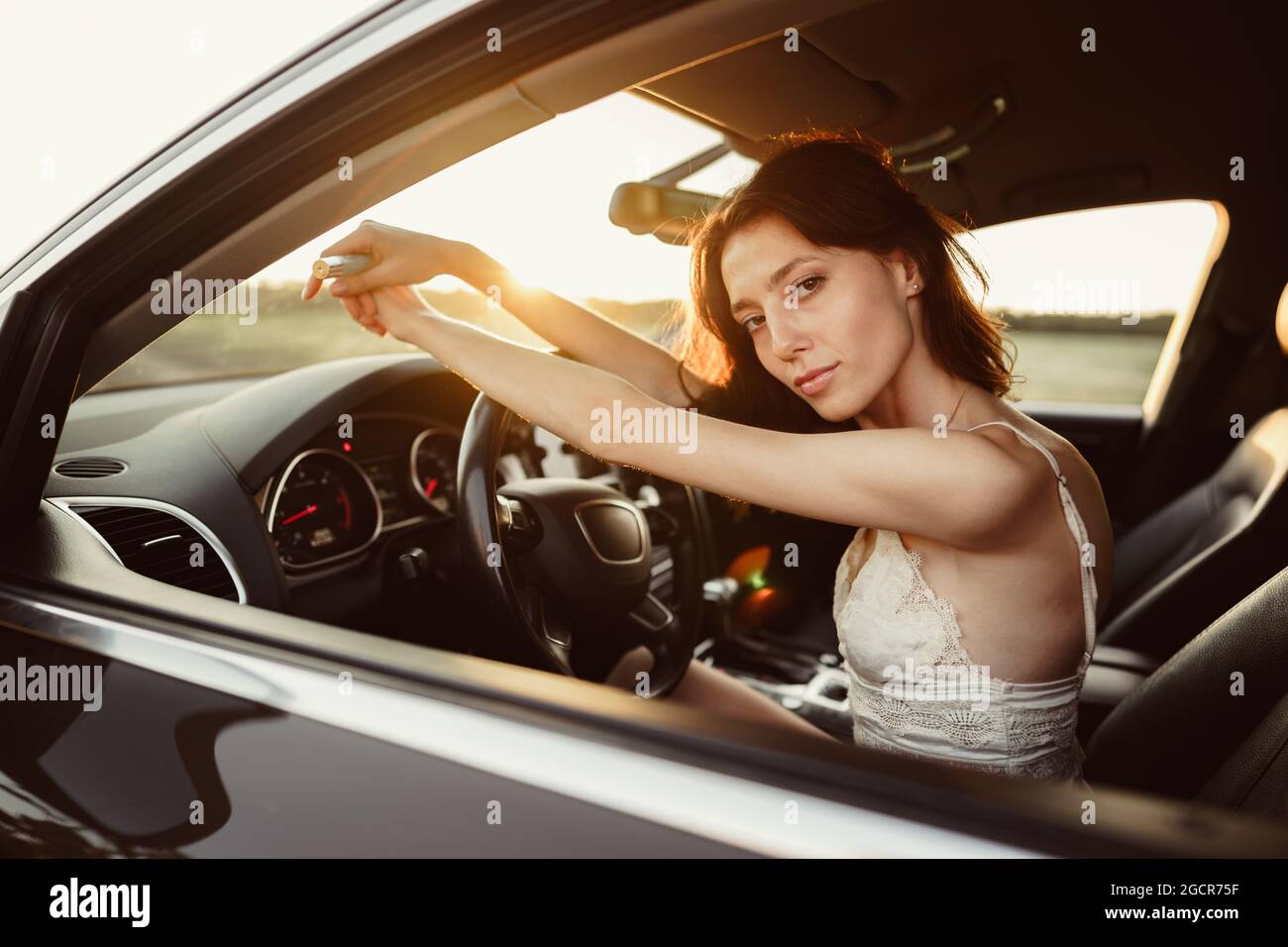 Beautiful smiling woman driving her car in the morning Stock Photo - Alamy