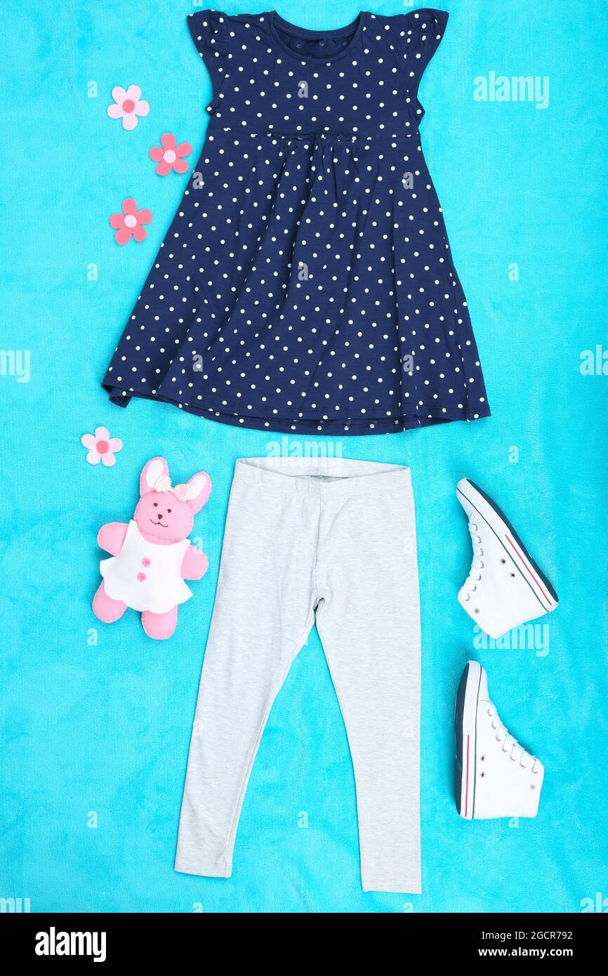 Beautiful clothes for little girl on blue background Stock Photo - Alamy