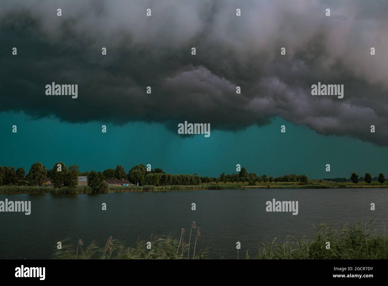 Green blue sky below the base of a shelf cloud of a severe thunderstorm ...