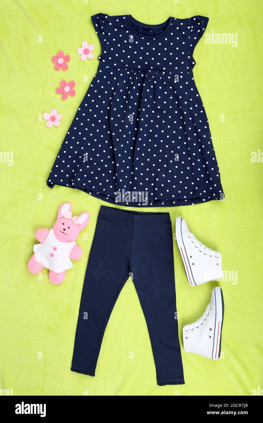 Beautiful clothes for little girl on green background Stock Photo - Alamy