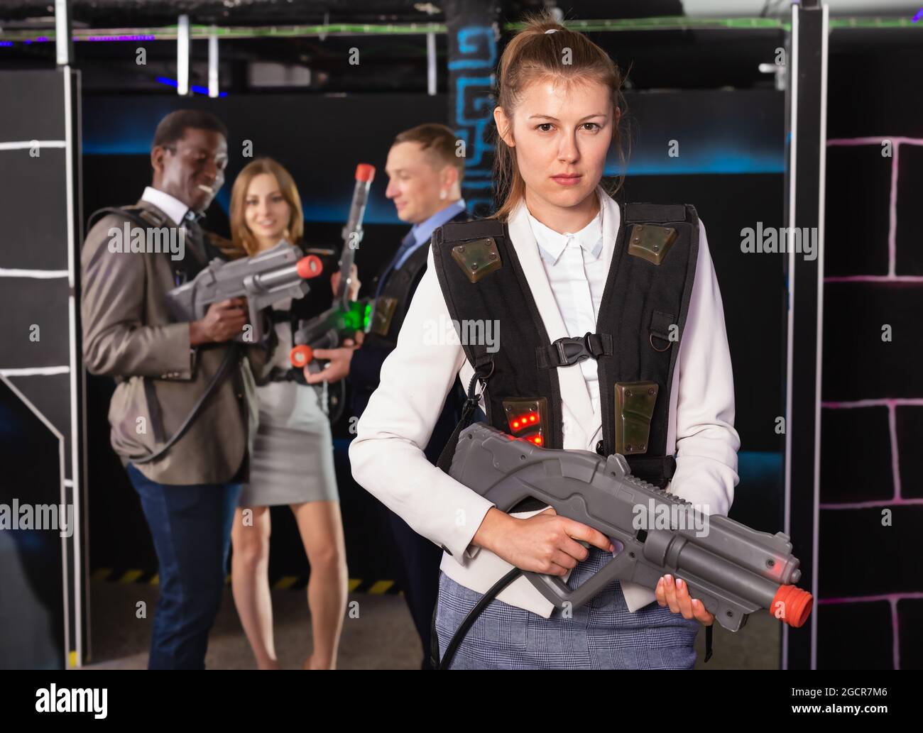 Woman holding laser gun and playing laser tag Stock Photo - Alamy