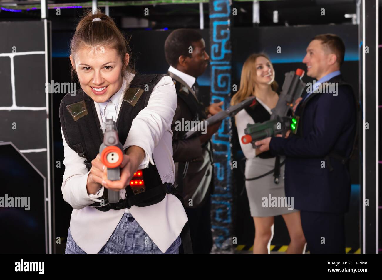 Woman holding laser gun and playing laser tag Stock Photo - Alamy