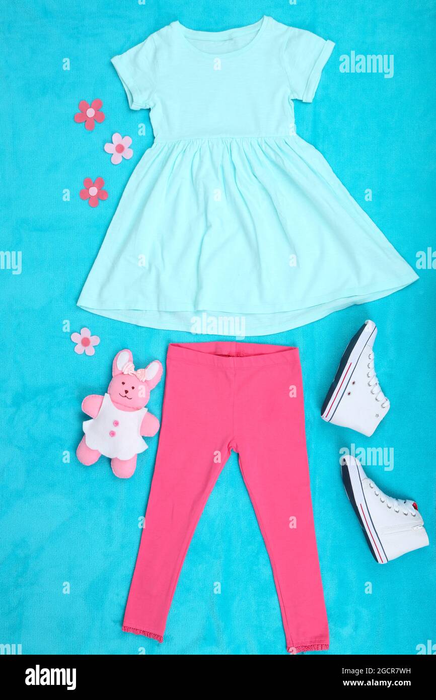 Beautiful clothes for little girl on blue background Stock Photo - Alamy