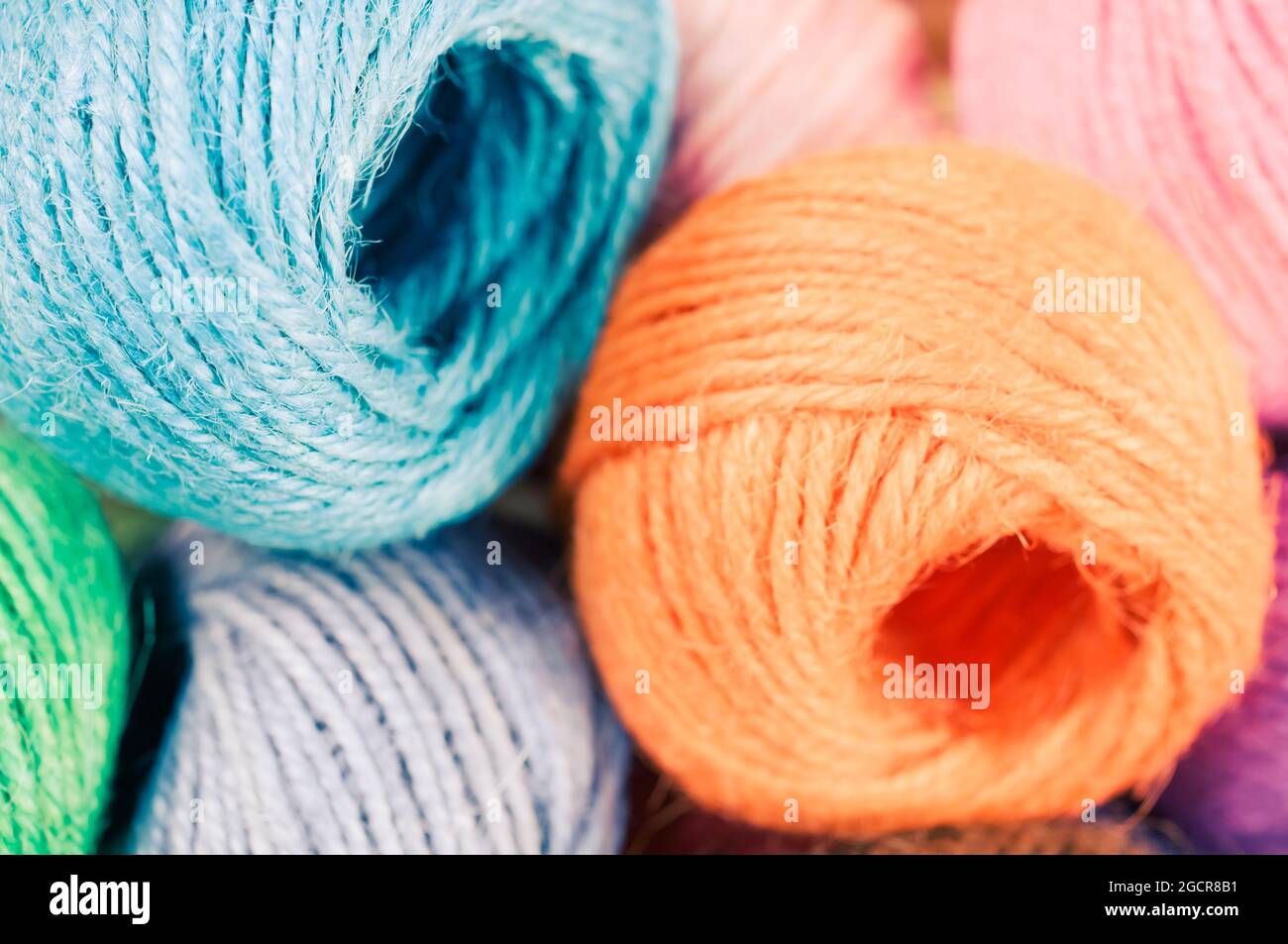 Colorful yarn rolls background Stock Photo - Alamy