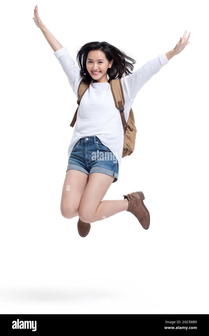 Happy young woman jumping Stock Photo - Alamy