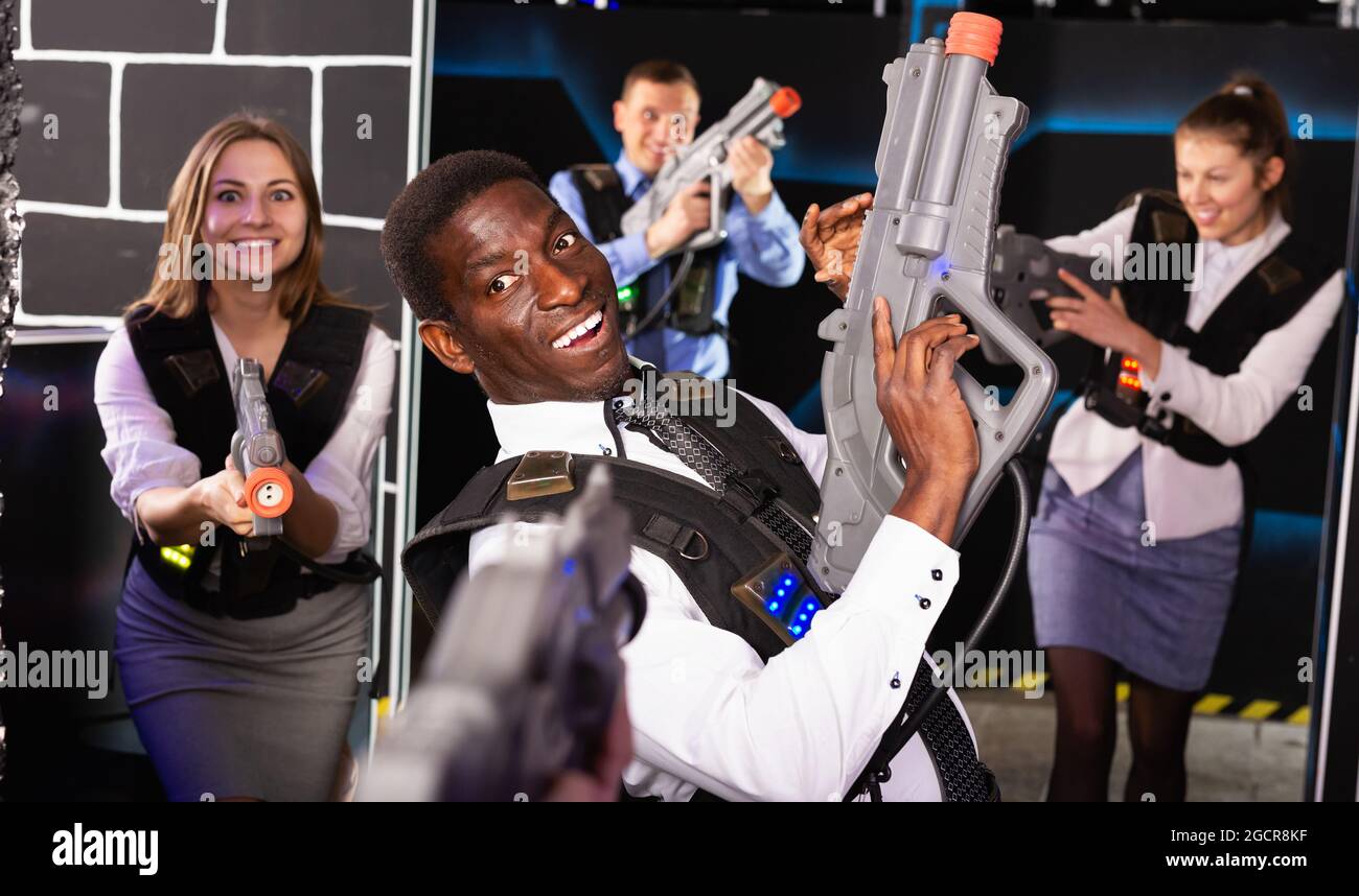 Afro businessman playing laser tag Stock Photo - Alamy