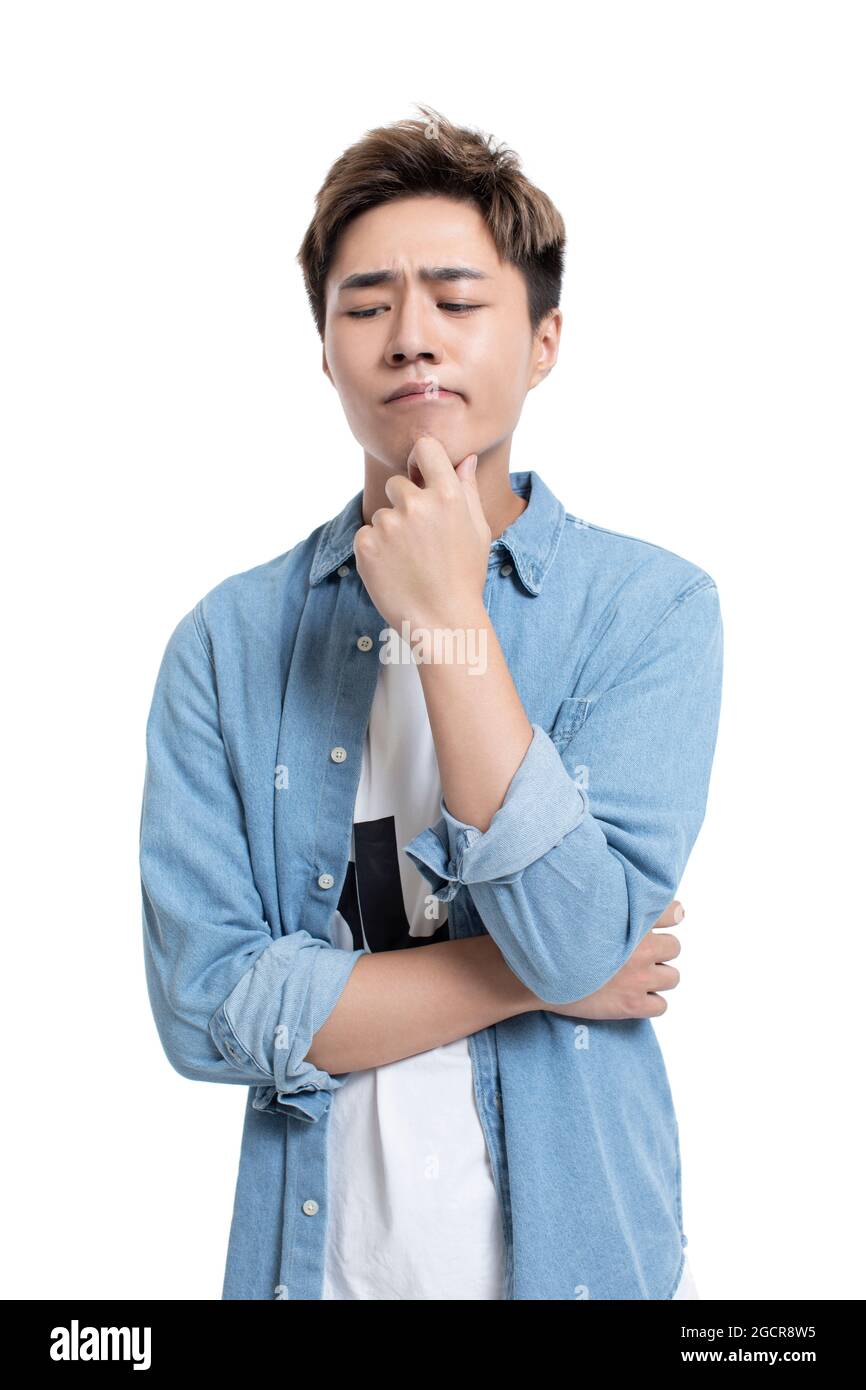 Young man thinking Stock Photo - Alamy