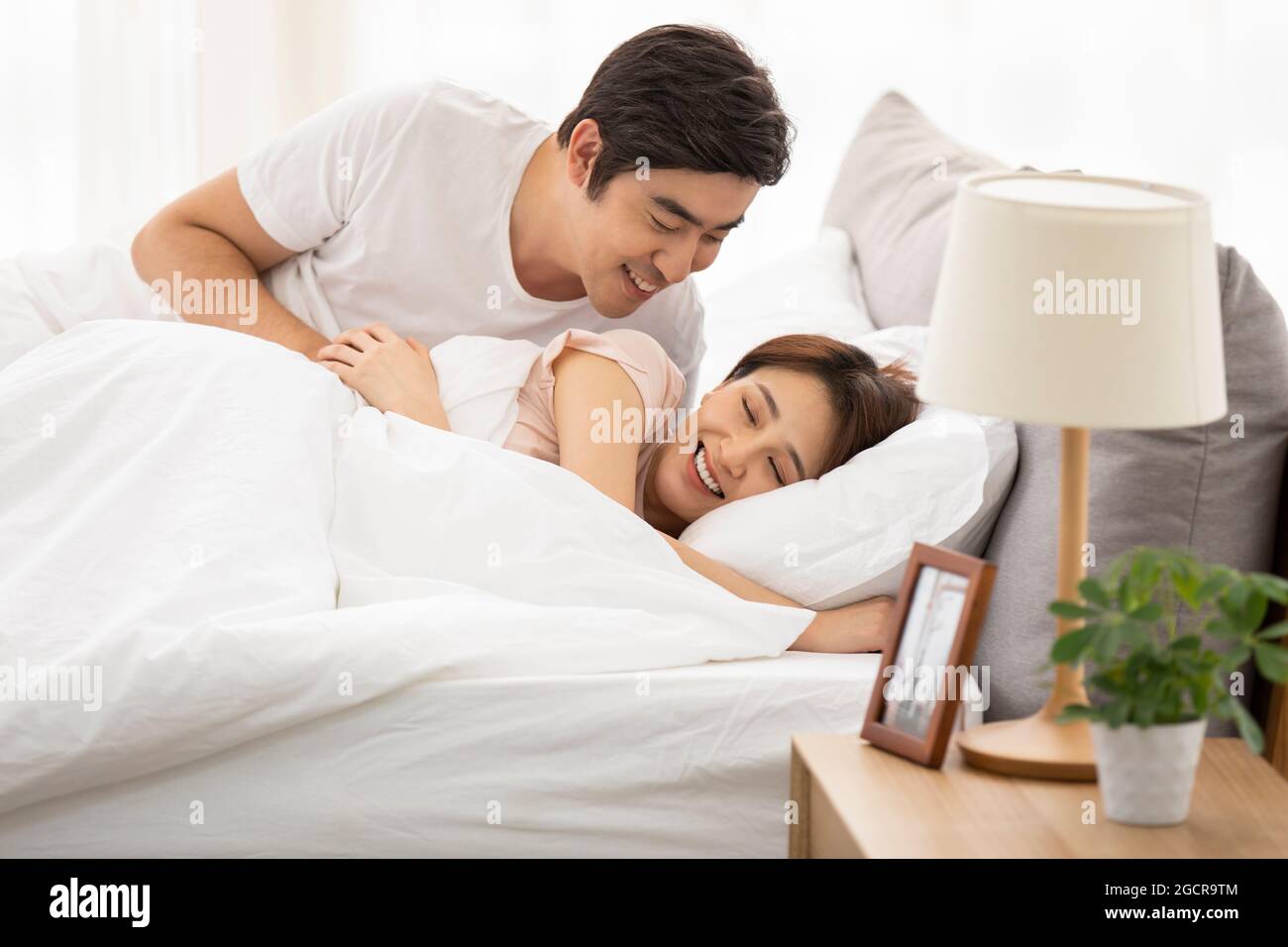 Asian couple waking up in hi-res stock photography and images - Alamy