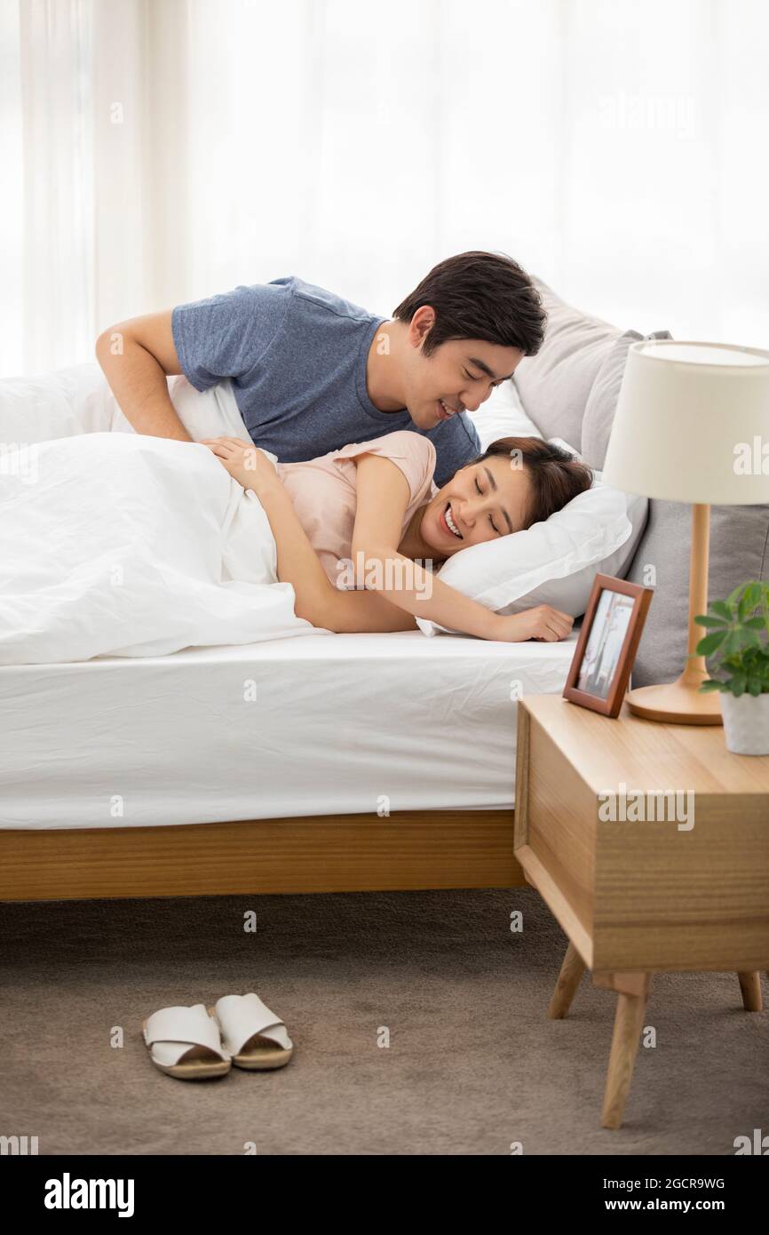Young couple sleeping in bed Stock Photo - Alamy