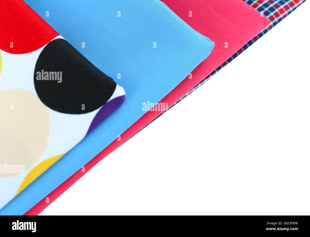 Pile of colored fabrics isolated on white Stock Photo - Alamy