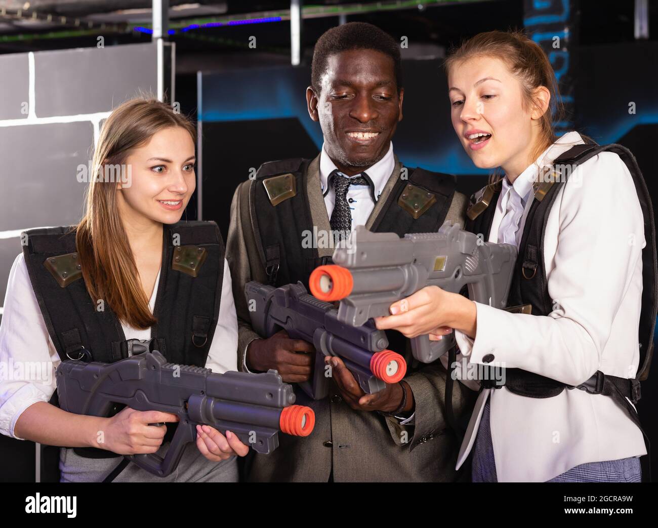 African man and happy women holding laser guns Stock Photo - Alamy