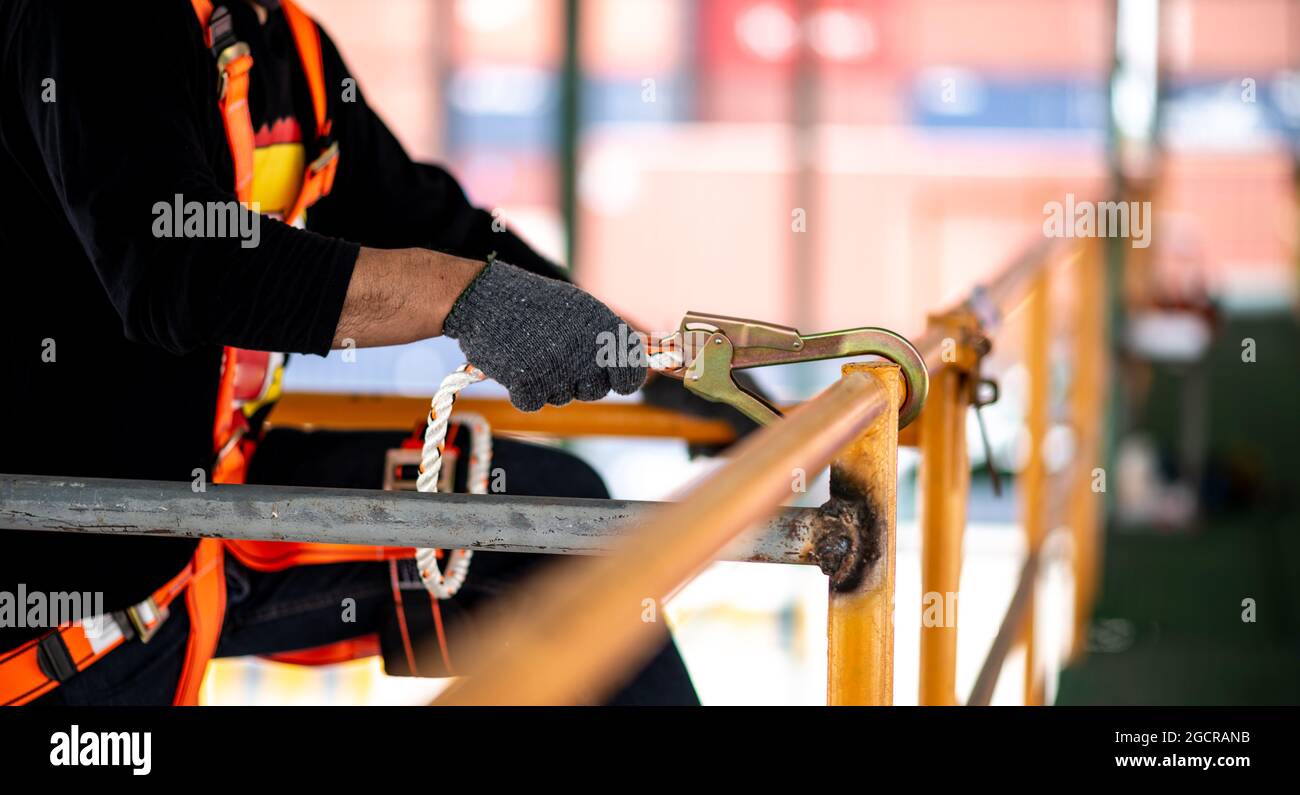 Construction worker wearing safety harness and safety line working at ...