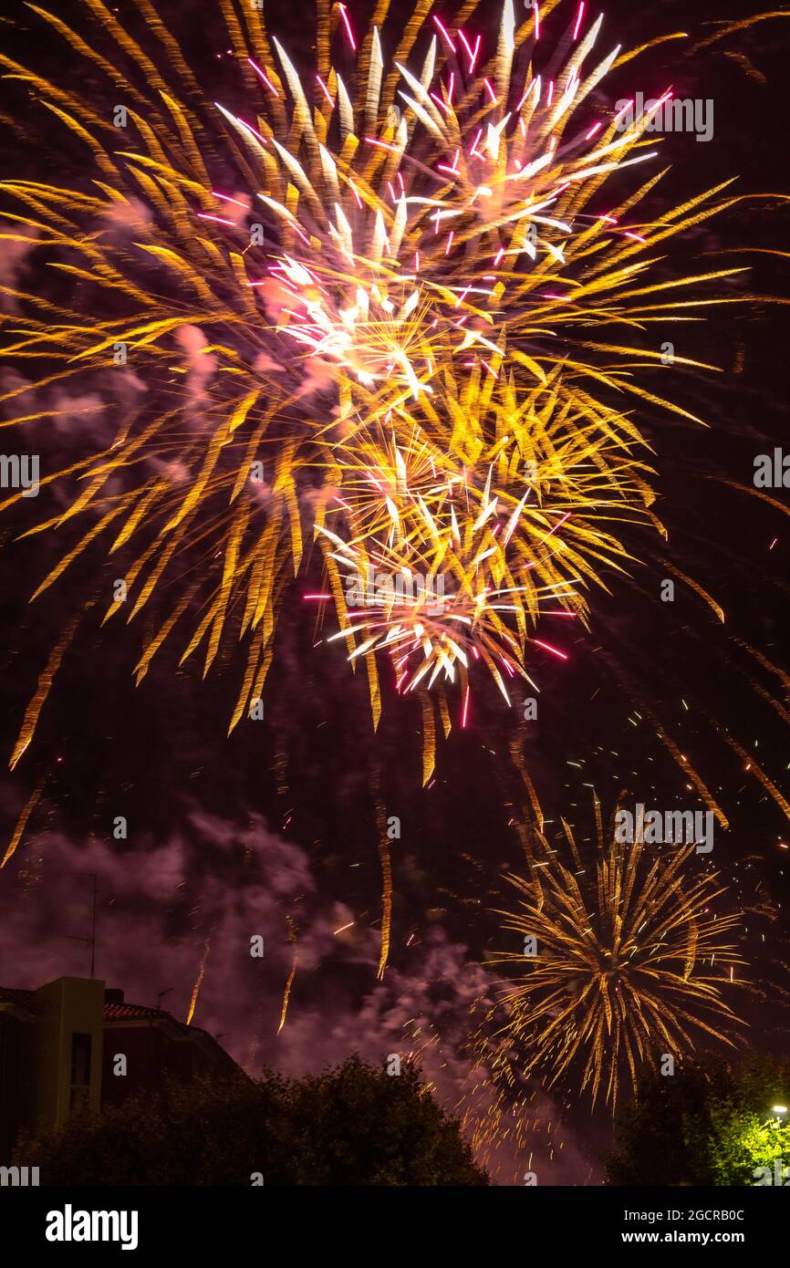 fireworks of different colors in the middle of the night of a day of ...