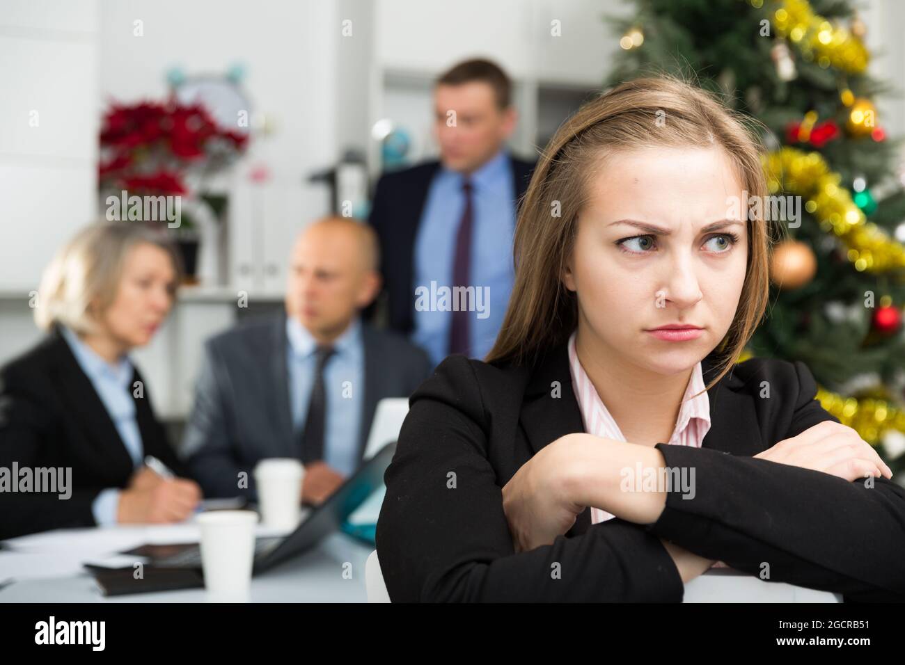 Business team tensely solving problems in office with upset woman ...
