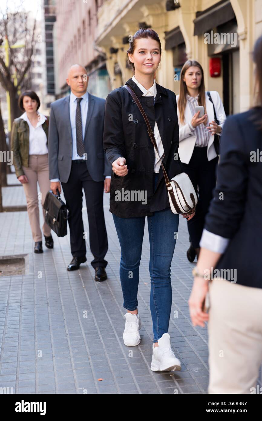 People in formal wear walking down street in city Stock Photo - Alamy