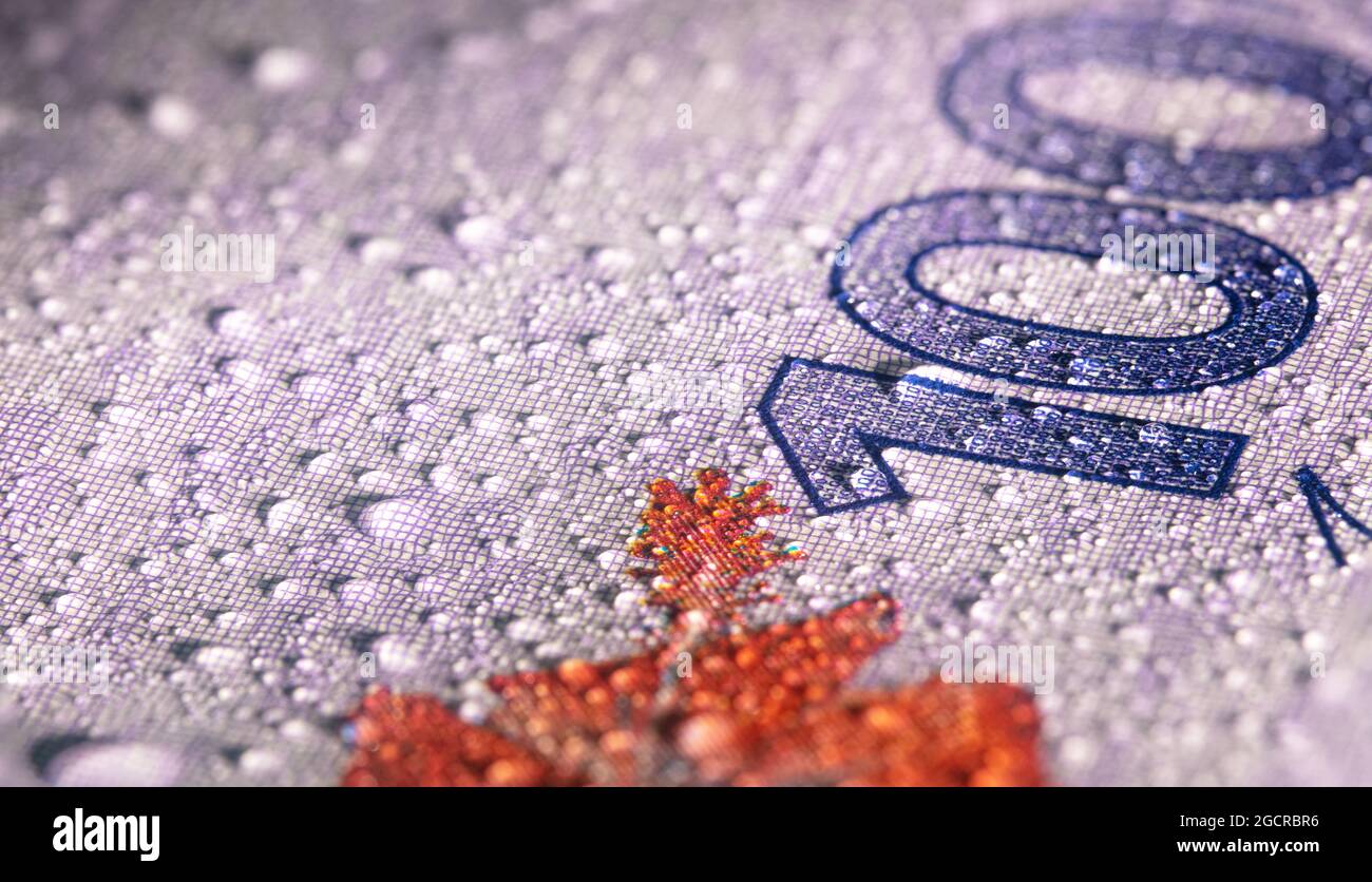Close-up to the water resistant surface of a 100 Ringgit banknote ...
