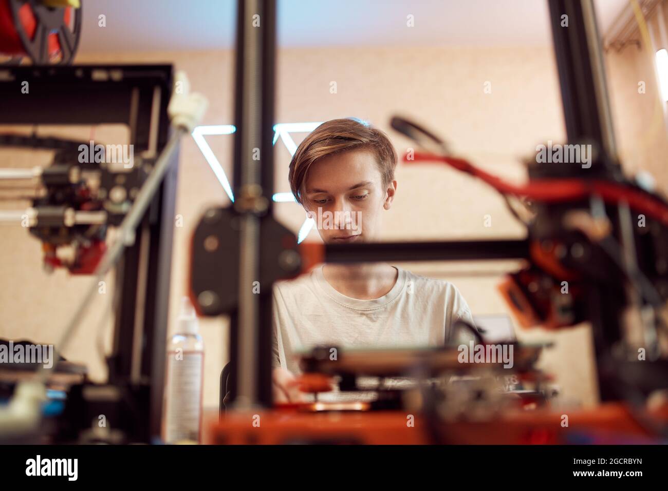 Young man set up 3d printer at home Stock Photo - Alamy