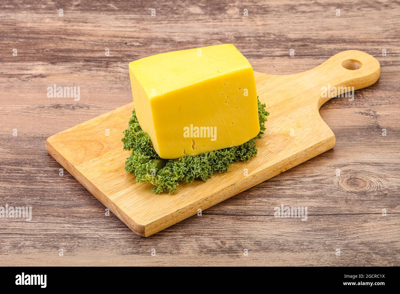 Yellow tilsiter cheese dairy product brick Stock Photo - Alamy