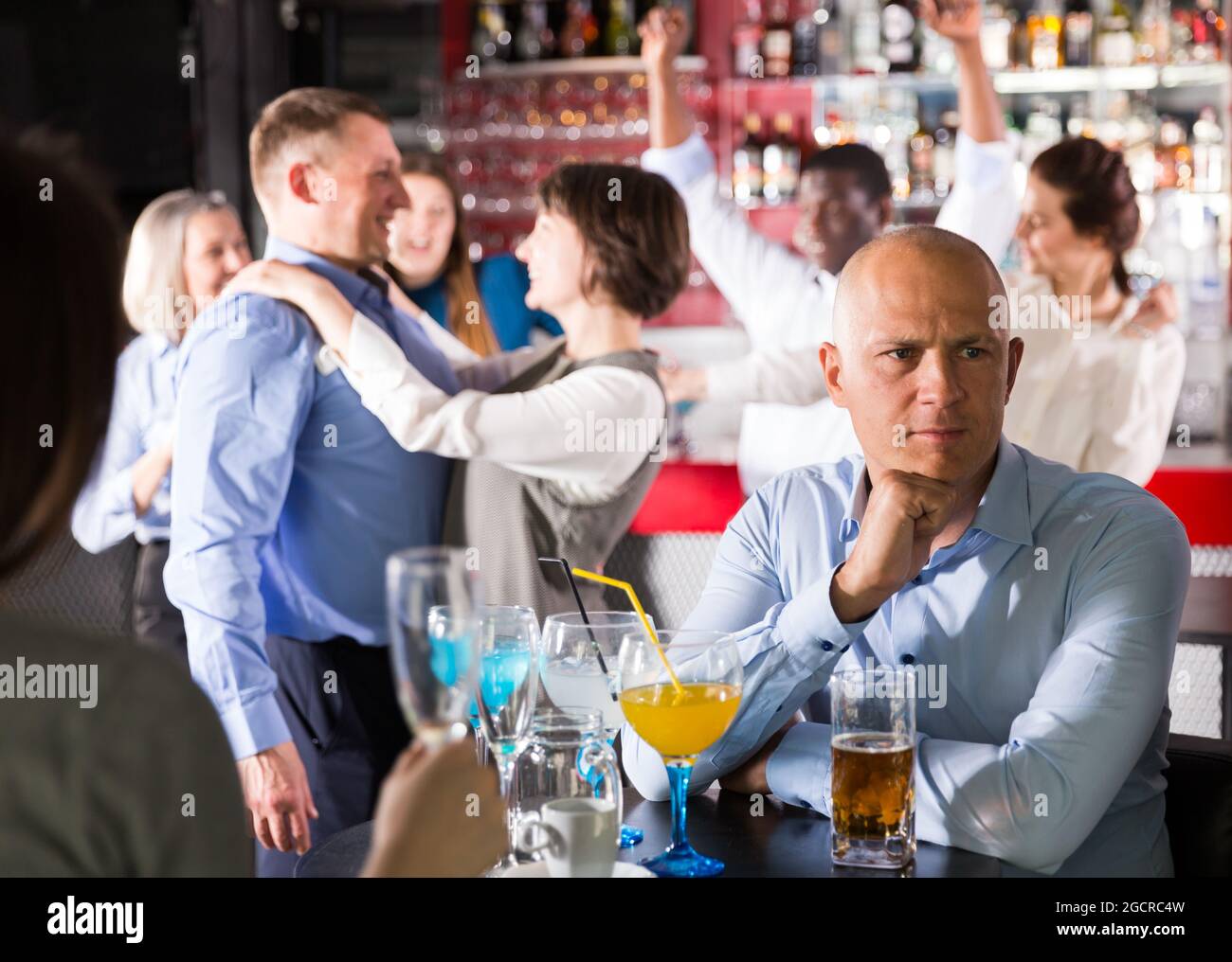 Troubled man at office party Stock Photo - Alamy