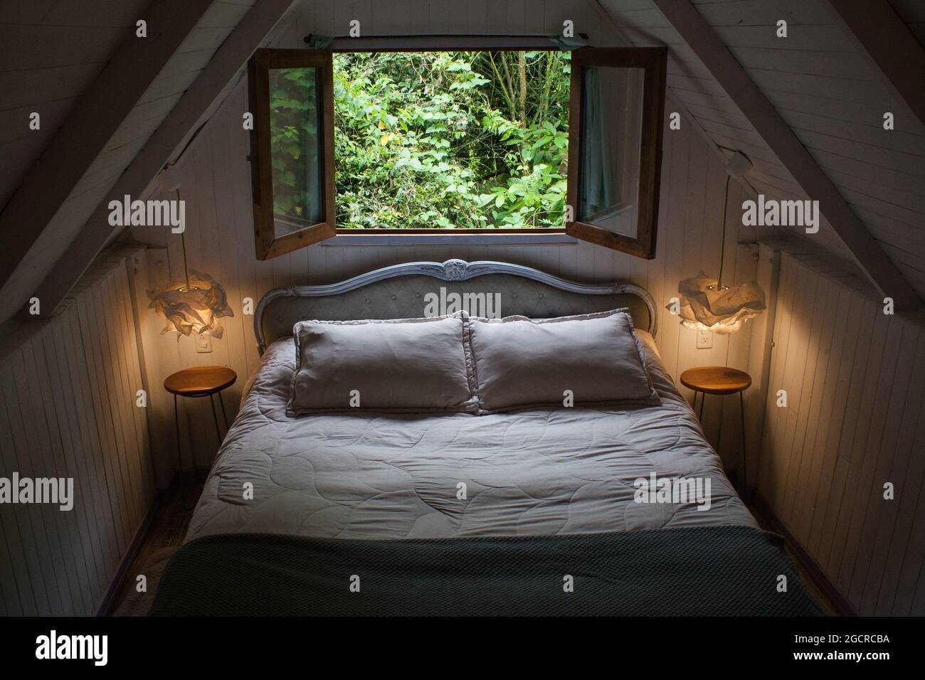 Cozy bedroom with open windows with a view of a forest Stock Photo - Alamy