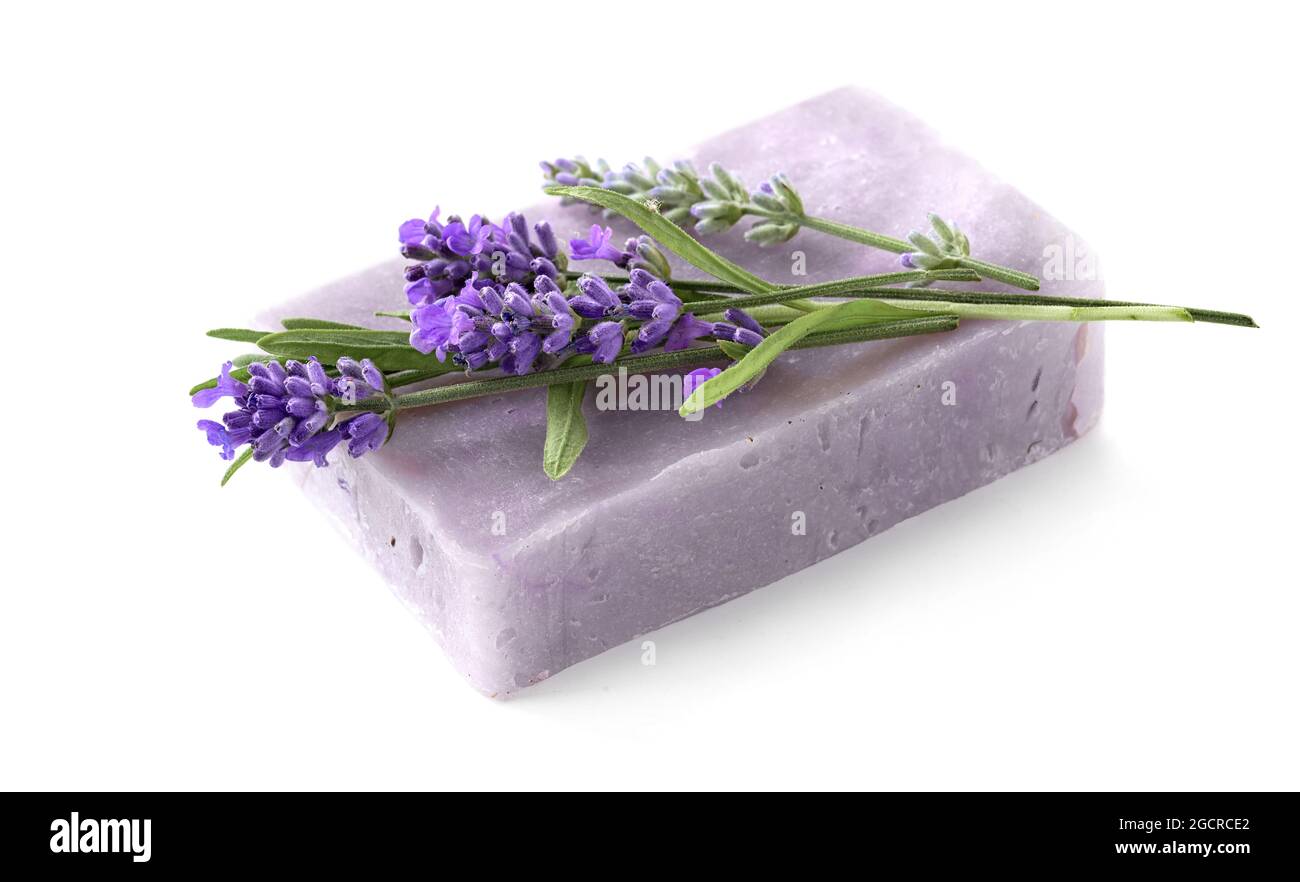 Homemade lavender soap bar with lavender flowers atop isolated on white ...