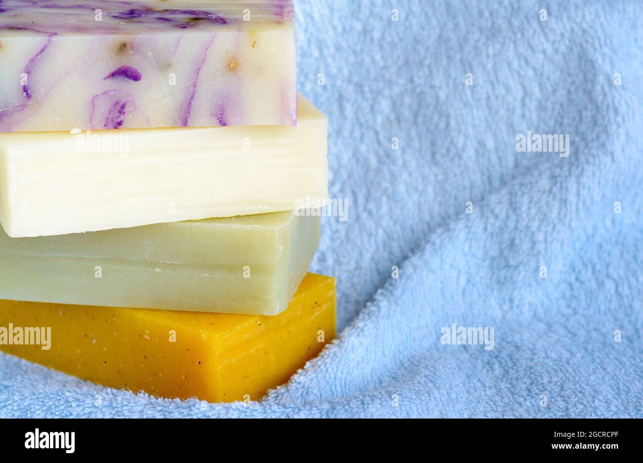 Natural handmade soaps on blue bath towel background Stock Photo - Alamy