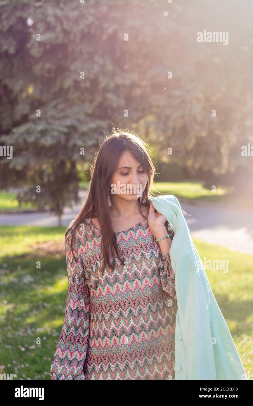 Colorful candid portrait of a young brunette woman during golden hour ...