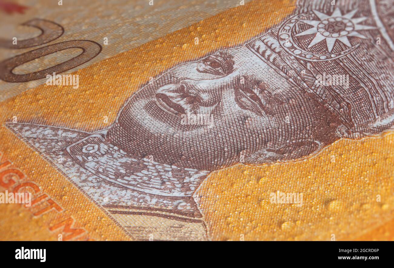 Close-up to the water resistant surface of a 20 Ringgit banknote. Water ...