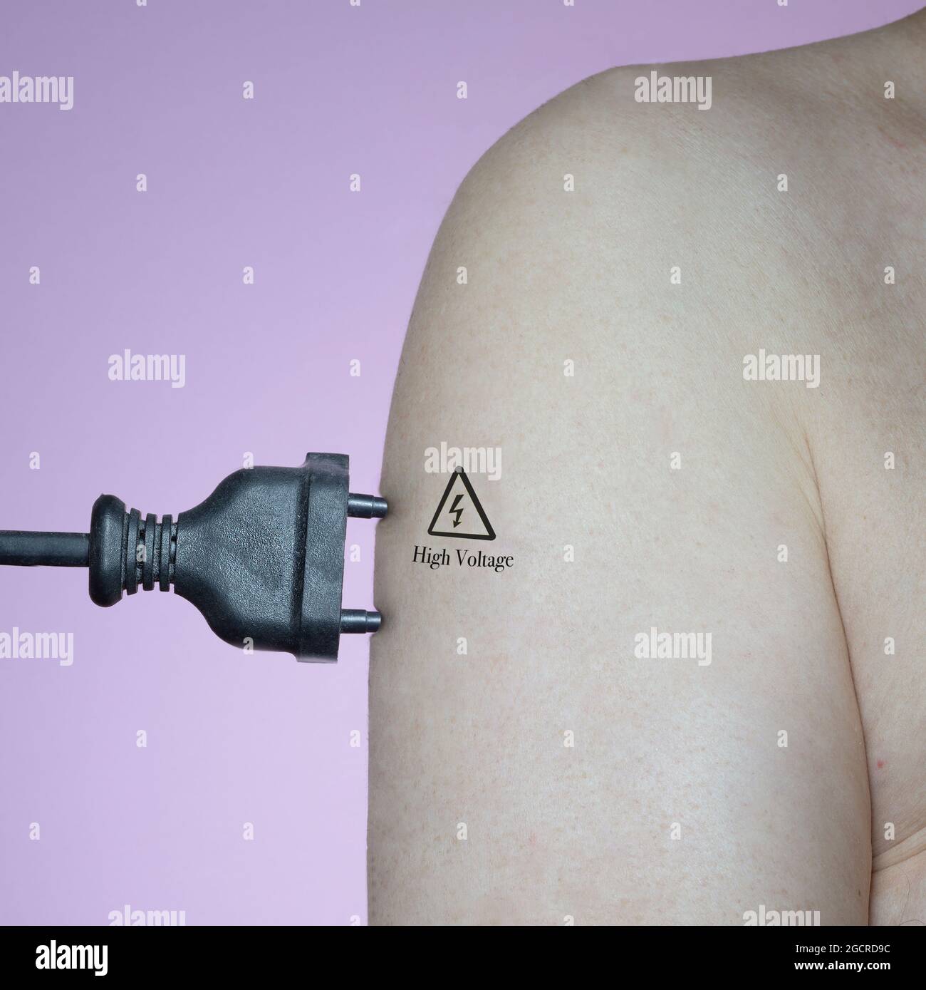 a man connected with a plug to the electric power in his arm Stock ...