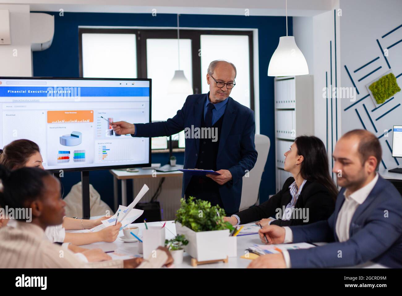 Senior manager holding business training explaining in conference room ...