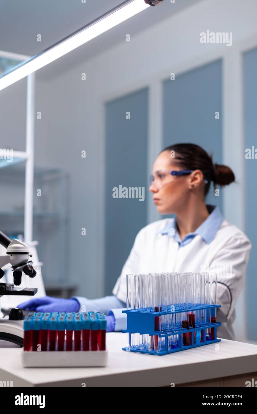 Microbiology scientist typing biochemistry discovery experiment at ...