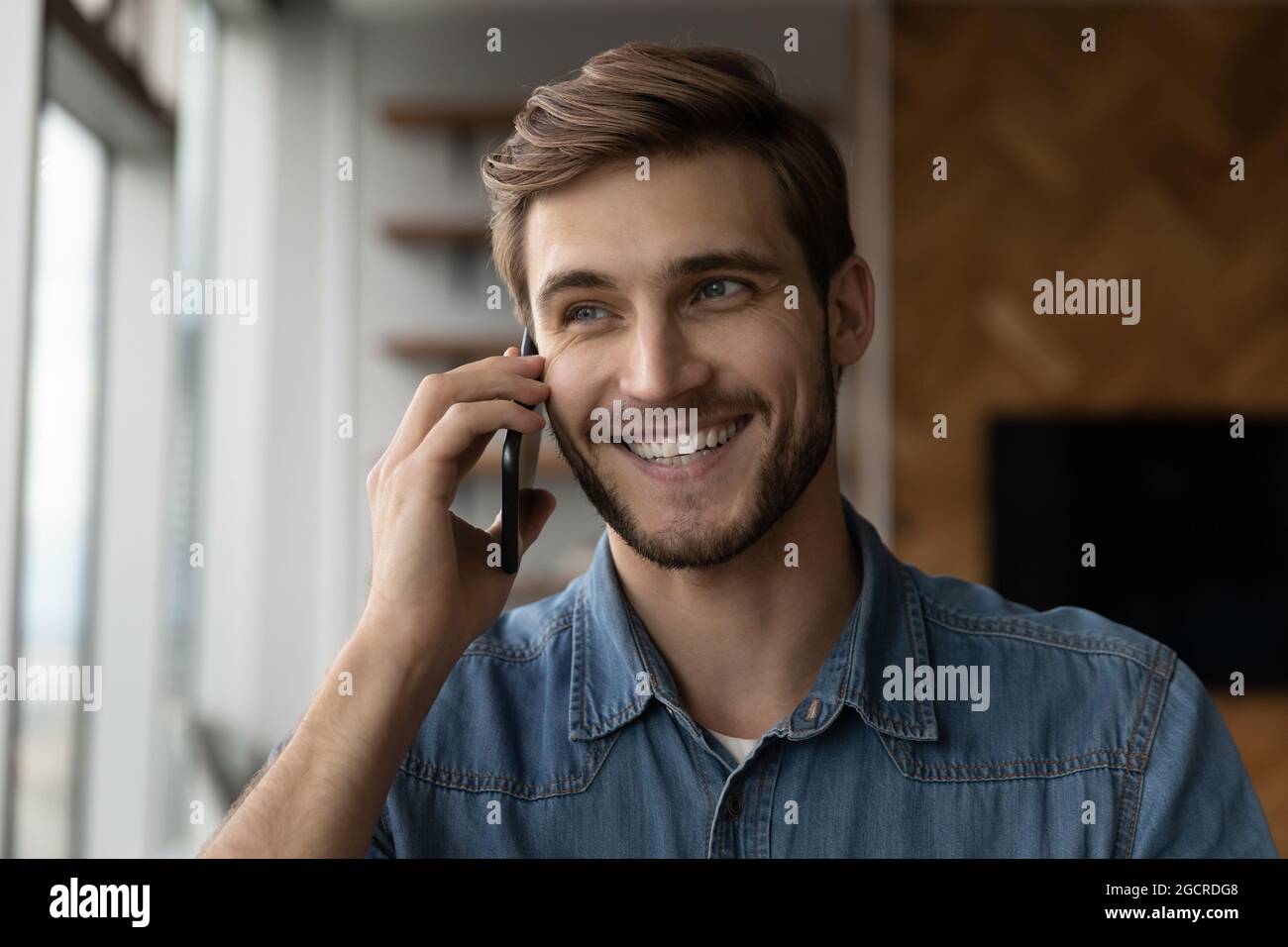 Happy positive millennial man making call, talking on cellphone Stock ...