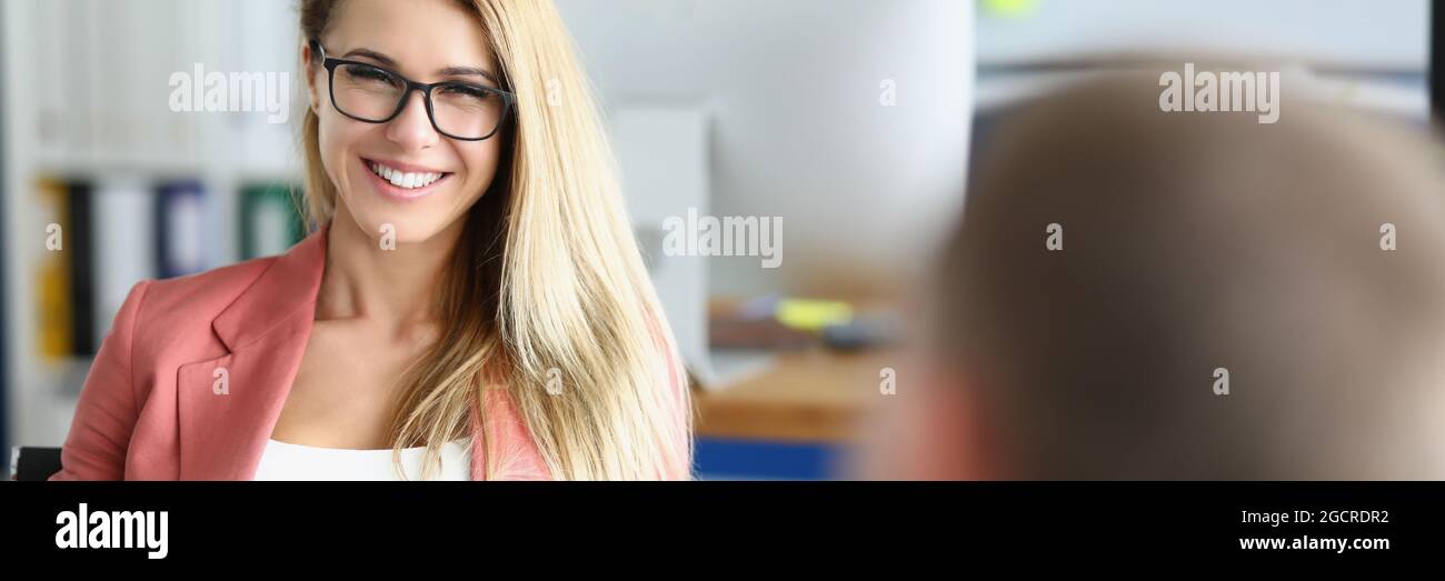 Smiling businesswoman communicating with client in office Stock Photo ...