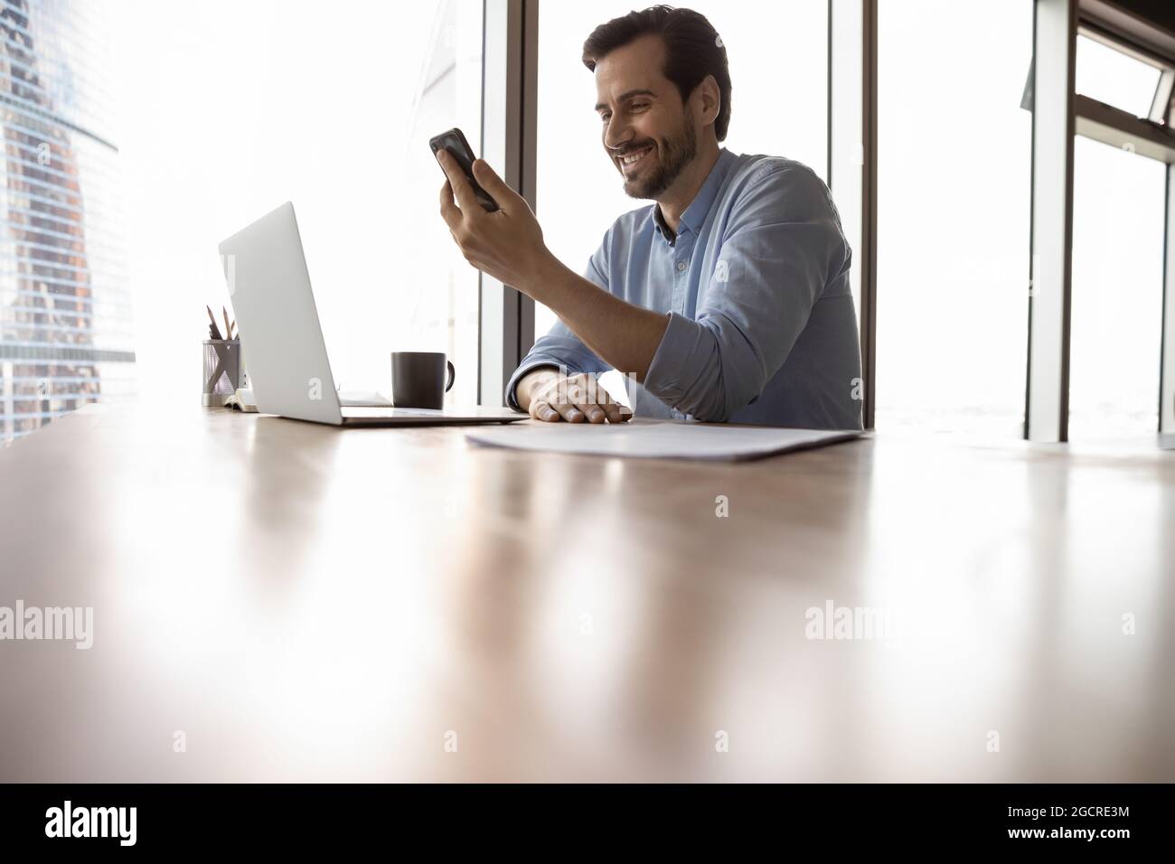 Happy male business leader, businessman with smartphone making video ...