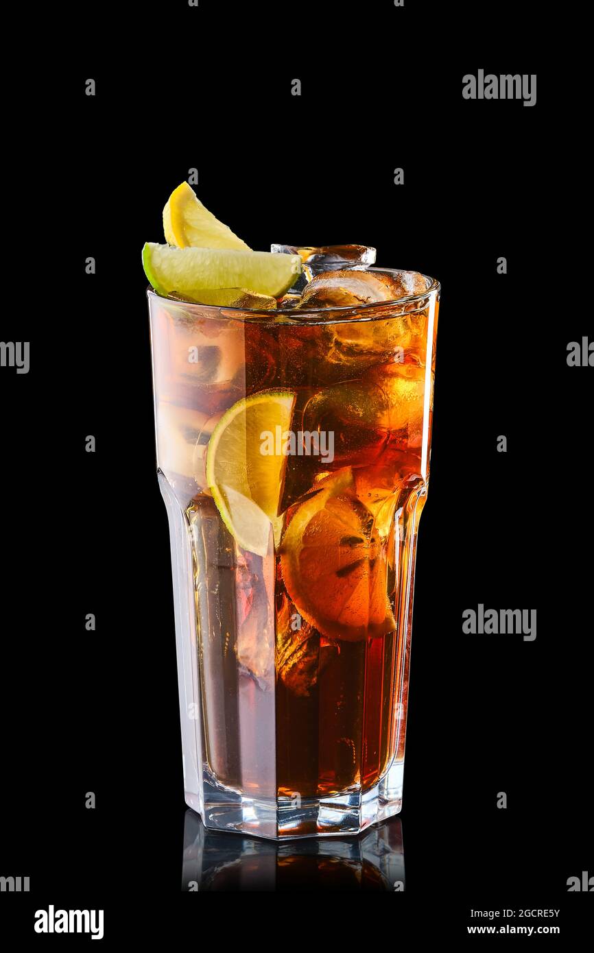 Cold cola with slices of lime and lemon isolated on black background ...