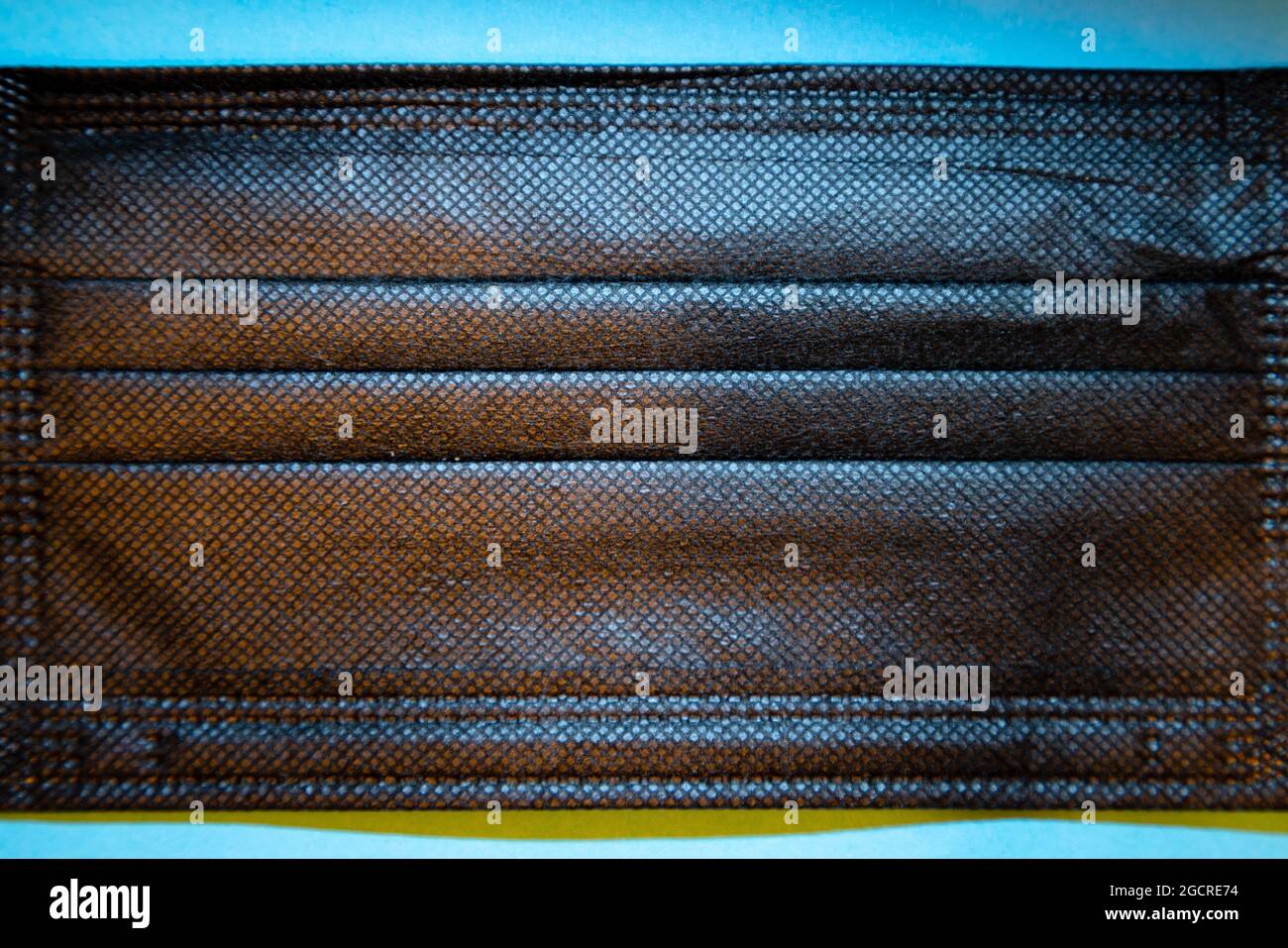 Black medical face mask texture. Close up of surgical mask fabric with ...