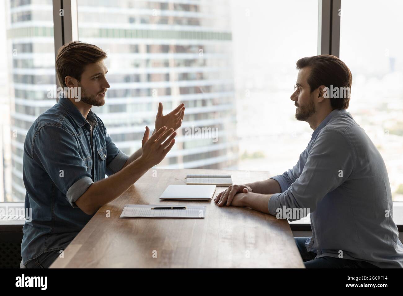 Two businessmen, business partners meeting in office for negotiation ...