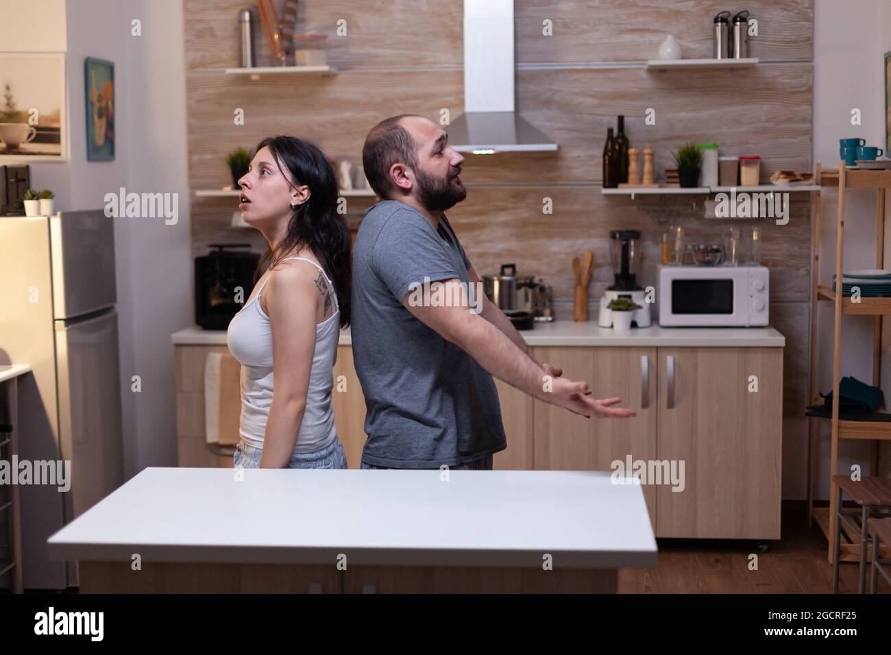 Husband and wife having jealousy conflict fighting. Couple at home ...