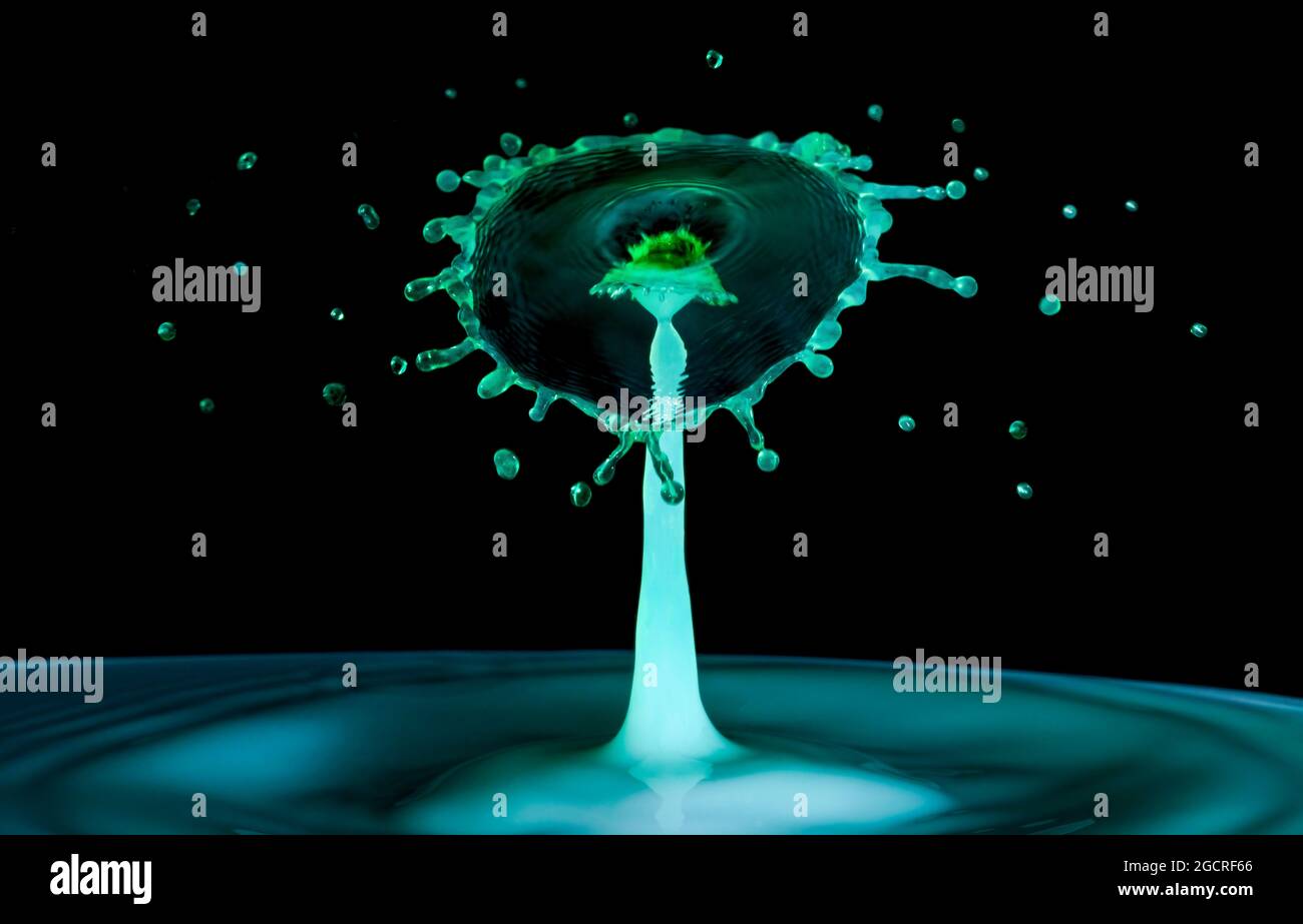 Close-up photograph of two water droplets colliding making an unusual ...