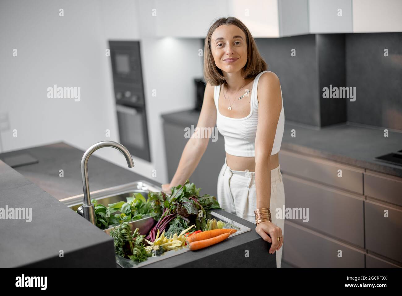 Woman washing fresh vegetables and greens in the sink Stock Photo - Alamy