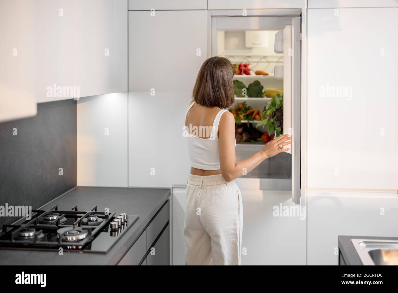 Modern woman and fridge hi-res stock photography and images - Alamy