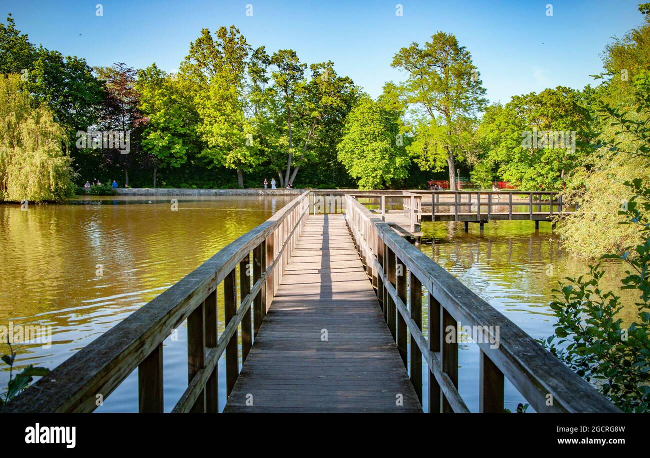 BUNDE, GERMANY. MAY 31, 2021. Lake view Small bridge People walking ...