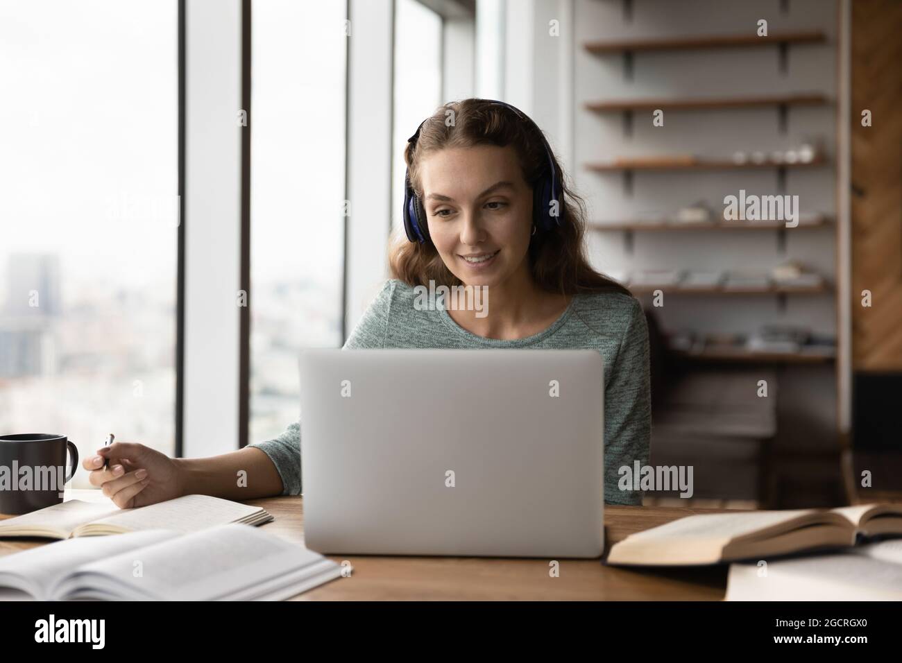 Happy gen Z student girl involved in online learning event Stock Photo ...