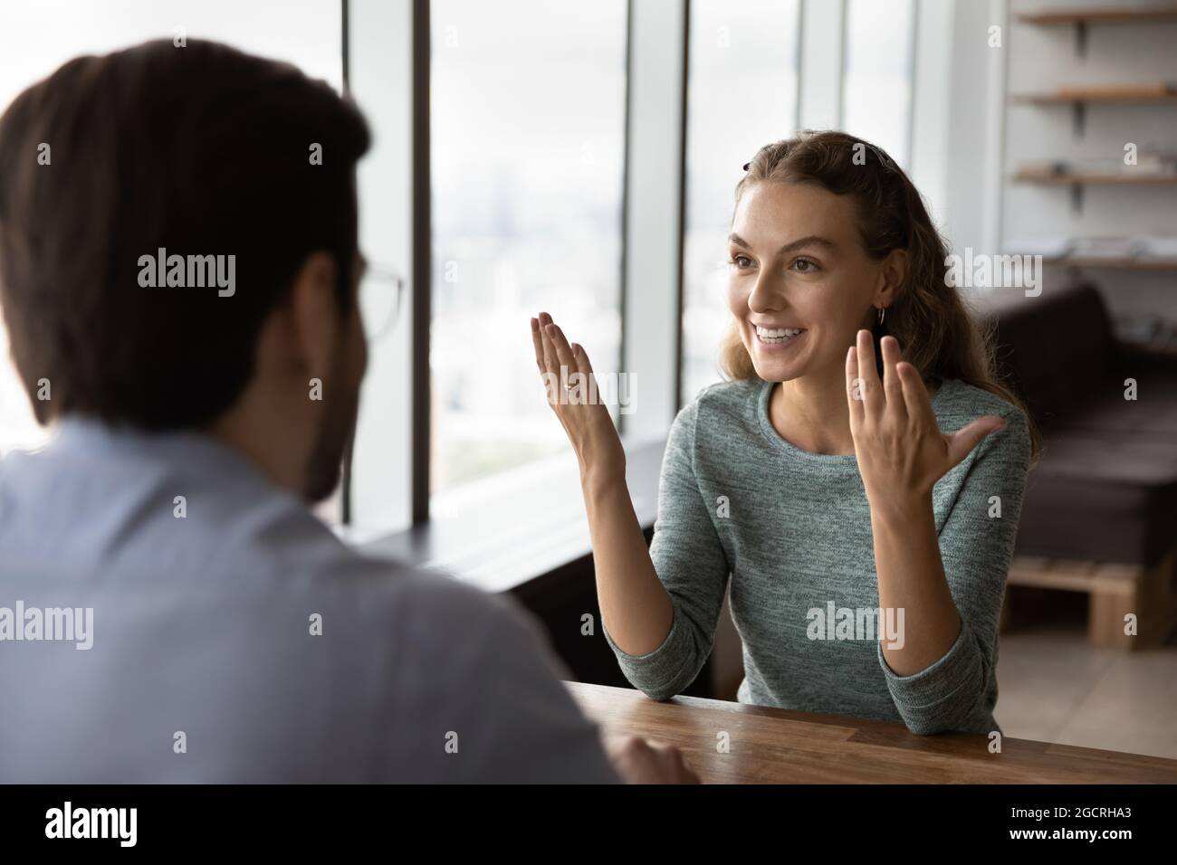 Happy confident candidate telling about experience at job interview ...