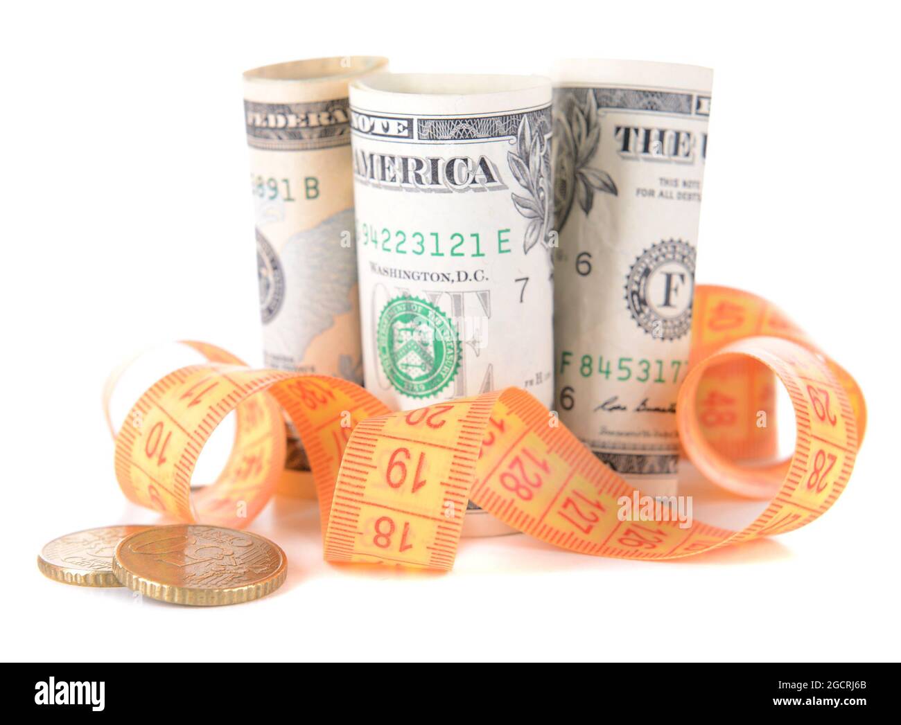 Tape measure with money isolated on white Stock Photo - Alamy