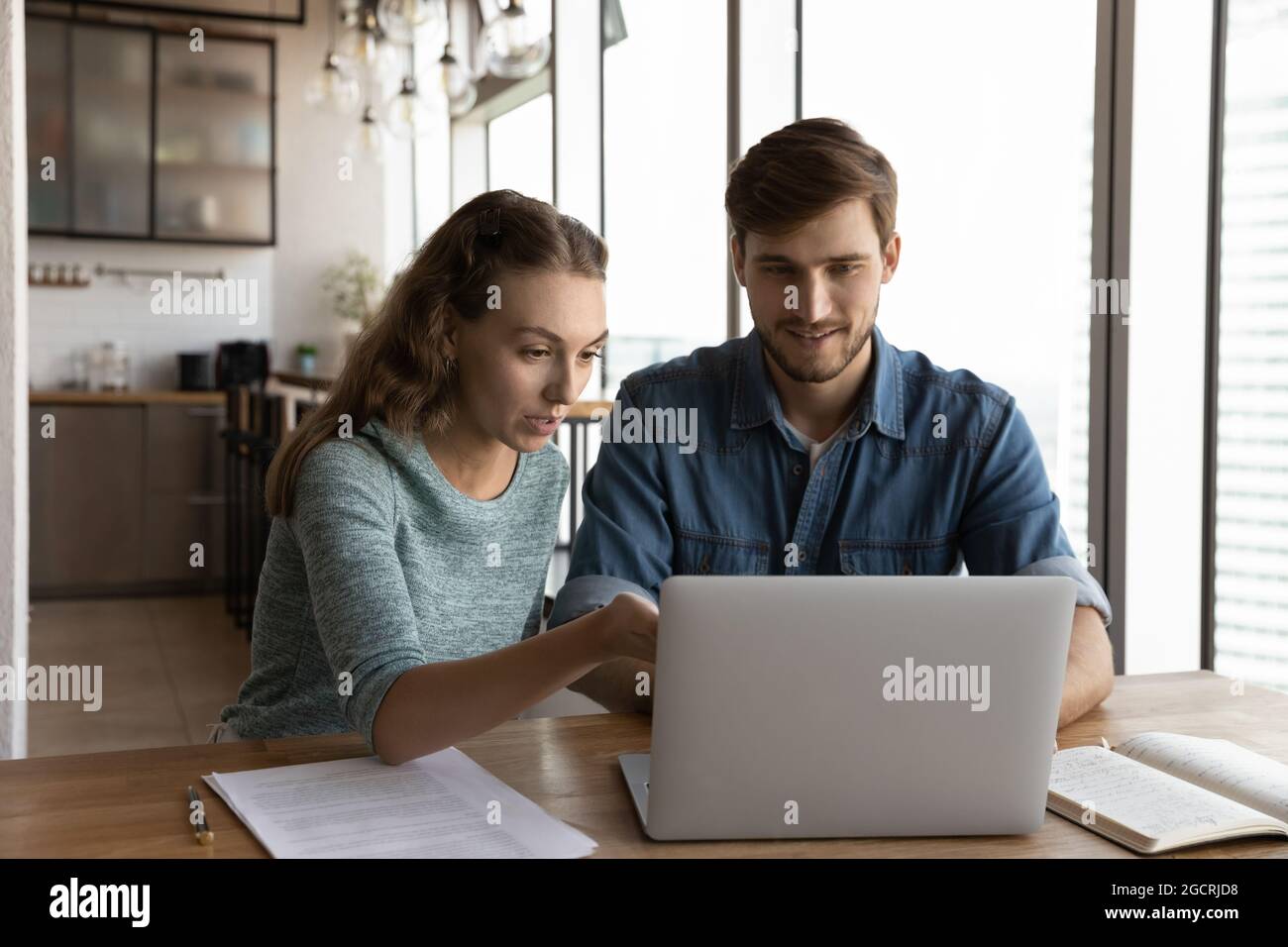 Young female mentor training new employee, explaining giving ...