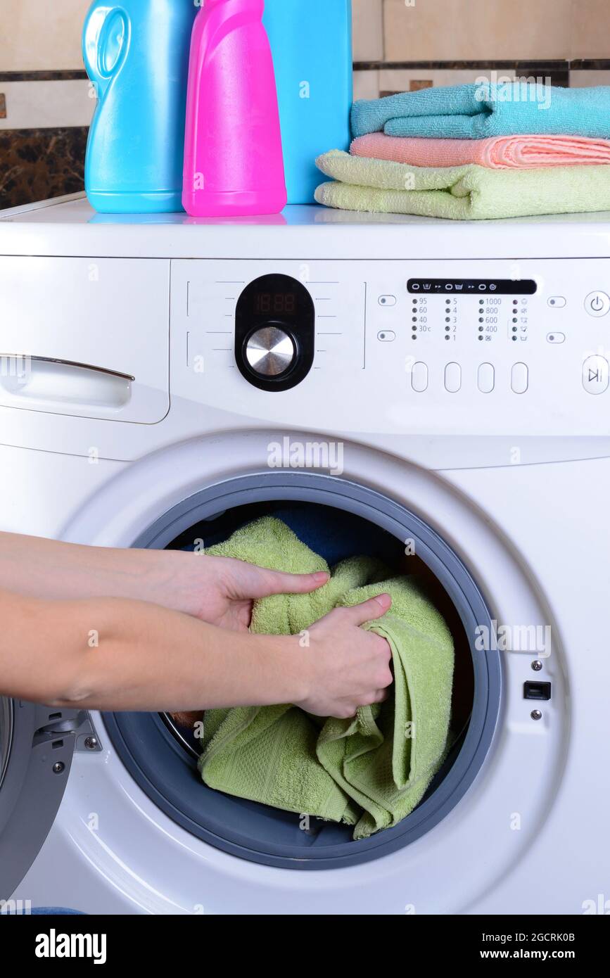 Washing machine loaded with clothes close-up Stock Photo - Alamy
